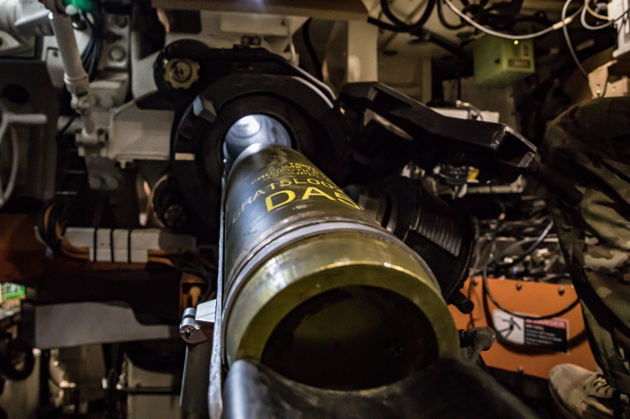 155mm artillery round rests on the ramming tray in preparation to be ...