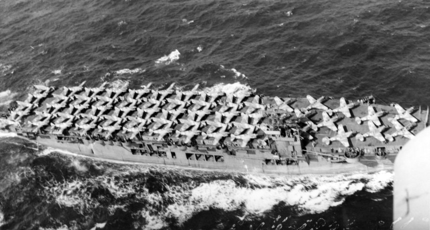 USS CHENANGO (CVE-28) ferrying army P-40F fighters to Morocco, with the ...