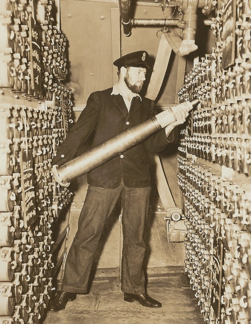 Chief Petty Officer placing a shell in the magazine rack on HMCS PRINCE ...